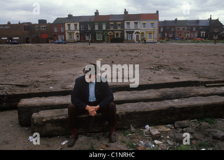 Urban poverty 1980s UK. Men sorting through stuff left after at the end ...