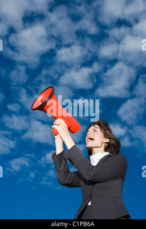 Woman shouting into megaphone, low angle view, cropped Stock Photo - Alamy