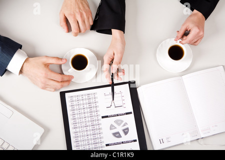 Above view of business people hands working with documents at briefing ...