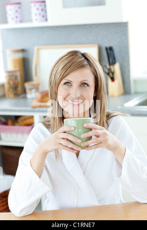Smiling woman drinking something Stock Photo - Alamy