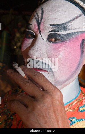Chinese opera performer smoking backstage in Bangkok, Thailand Stock ...