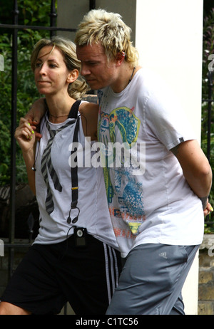 Natalie Appleton and Liam Howlett walk back from their local park after ...