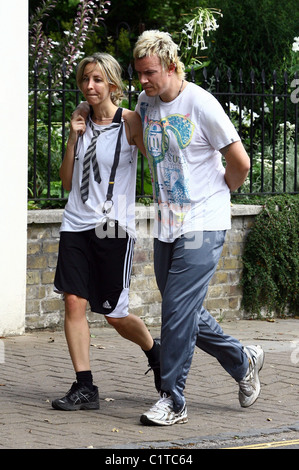 Natalie Appleton and Liam Howlett walk back from their local park after ...