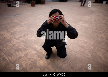 A blind photographer takes pictures during a photography workshop for ...