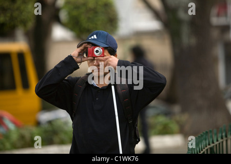 A blind photographer takes pictures during a photography workshop for ...