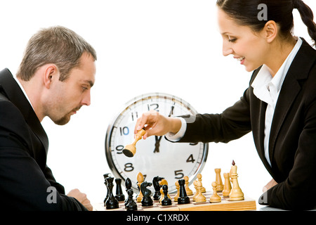 Confident business woman playing chess at the table. Intellectual duel ...
