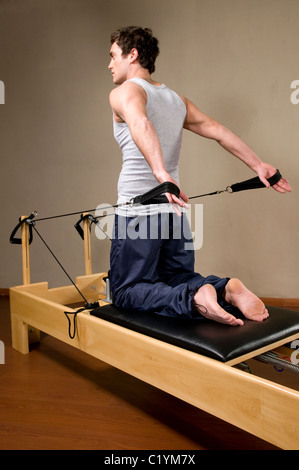 Man kneeling on floor, doing side stretch Stock Photo - Alamy