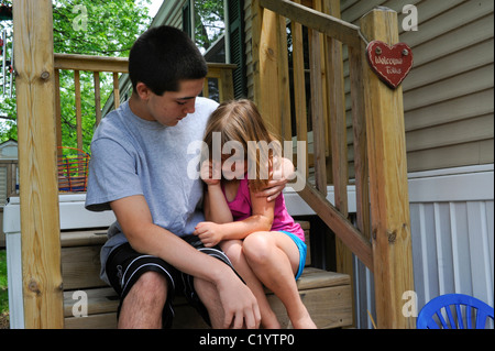 Boy consoling crying sister Stock Photo - Alamy