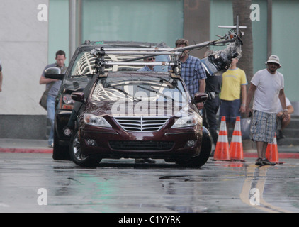 Leonardo DiCaprio driving a car in the rain while filming a scene for ...