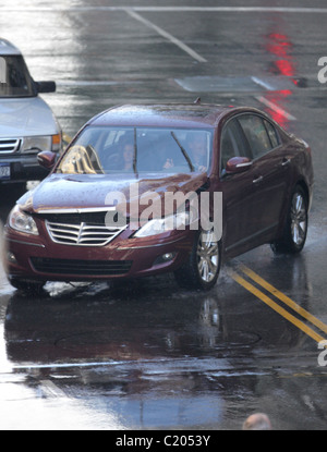 Actors stage a gun fight in the rain filming a scene for 'Inception ...