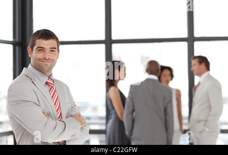 Handsome male manager leading his team Stock Photo - Alamy