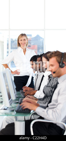 Cheerful female manager leading her representative team Stock Photo - Alamy