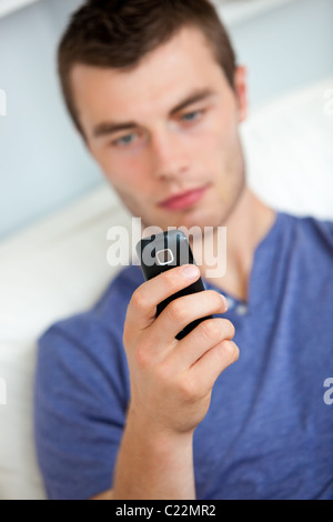 Concentrated young man writing a message Stock Photo - Alamy