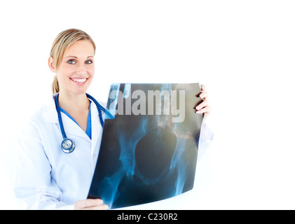 Ambitious female doctor looking at a x-ray against white background ...
