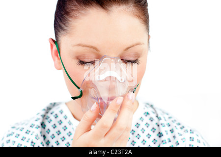 A woman wearing a face mask to help protect from the coronavirus walks ...
