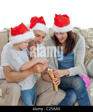 Family opening Christmas crackers Stock Photo - Alamy