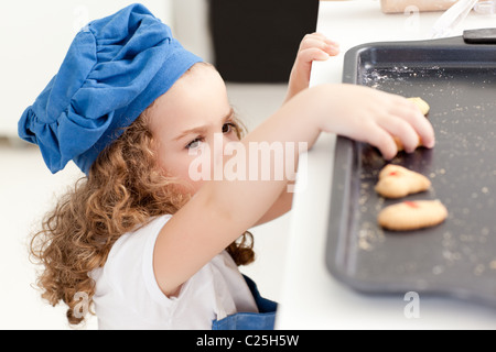 Little girl stealing cookies Stock Photo - Alamy