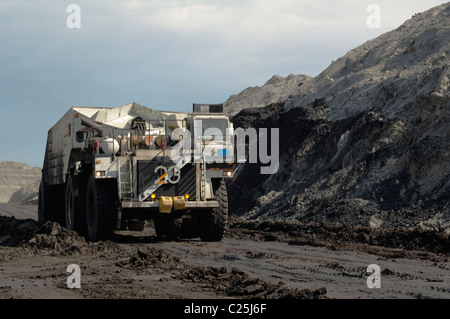 Coal mining industry, coal hauler truck inside of a massive open pit ...