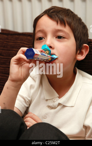5 year old boy eating Smarties Stock Photo - Alamy