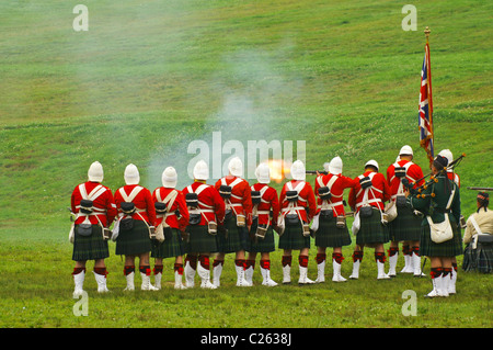 Men wearing the uniforms of The Gordon Highlanders with a replica Colt ...