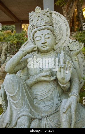 Buddhist statue of a female deity in park at the pagoda in Vietnam ...
