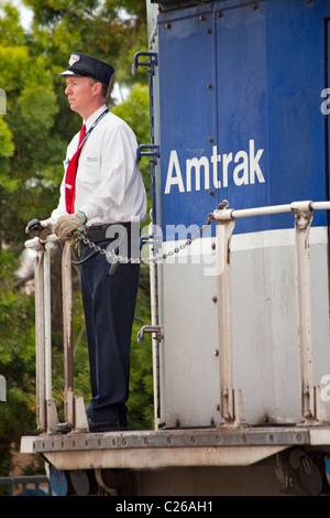 Amtrak railroad conductor assisting passenger at Deland Fl America USA ...