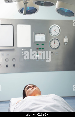 Patient lying on operation table while professional surgeons bending ...