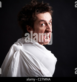 Insane man in strait-jacket screaming in isolation Stock Photo - Alamy