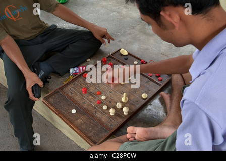 Thailand chess. Makruk. Men playing version of Thai chess board game ...