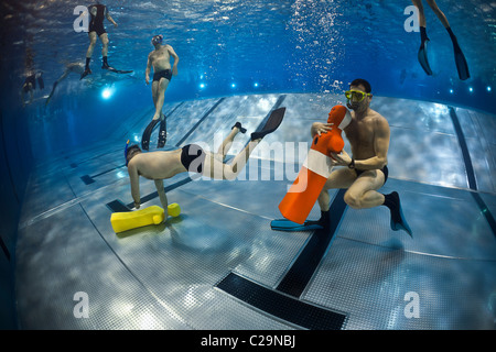 Lifeguard training with rescue dummy in a pool Stock Photo - Alamy