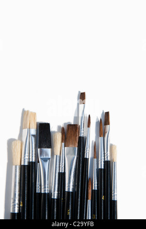 Assorted paint brushes on wooden background. Close-up Stock Photo - Alamy