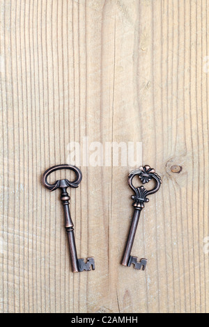old steel keys on a plank Stock Photo - Alamy