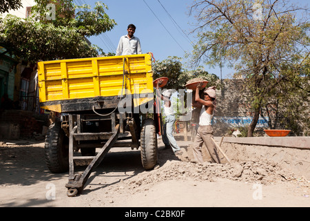 Indian construction truck carrying road workers on a Himalayan mountain ...