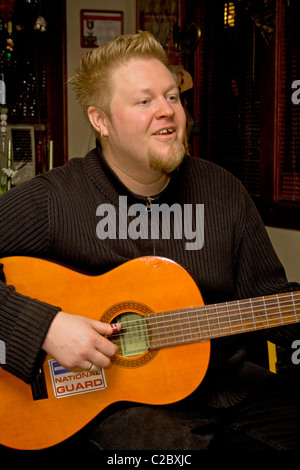 A man plays the guitar. Face of a man with a musical instrument on a ...