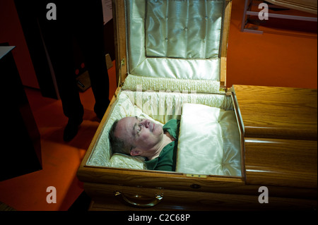 Deceased in coffin. Dead man lay in wooden casket. Corpse in an open ...