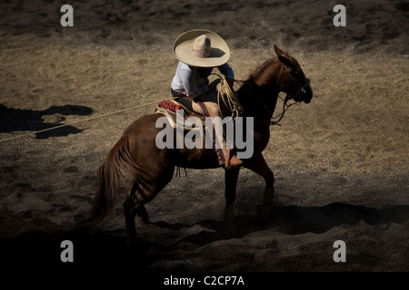 A Mexican Charro holds his lasso during a charreria exhibition in ...