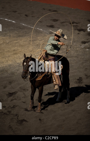 A Mexican Charro uses his lasso during a charreria exhibition in Mexico ...