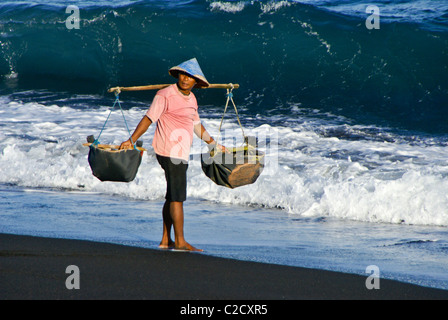 Man carrying sea water to make salt, Kusamba, Bali, Indonesia Stock ...