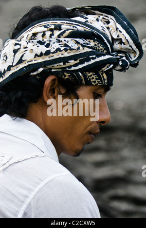 Balinese man wearing traditional headdress called udeng doing praying ...