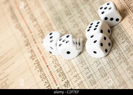 Dice and stock market charts in the newspaper Stock Photo - Alamy