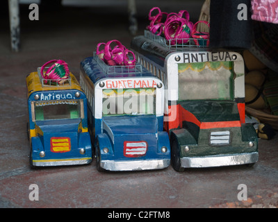 Toy wooden buses decorated to represent the "chicken buses," a typical ...