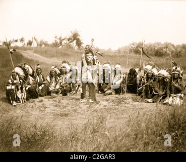 Chief Little Wound in council with other Indians, wearing feather ...