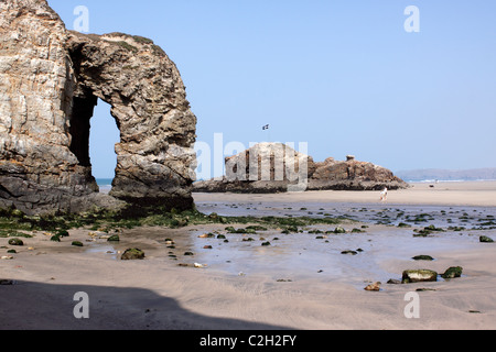 The natural sea arch and Chapel Rock on Perranporth Beach in Cornwall ...