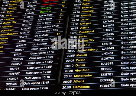 Airline flight schedule board at an airport showing delays and flight ...