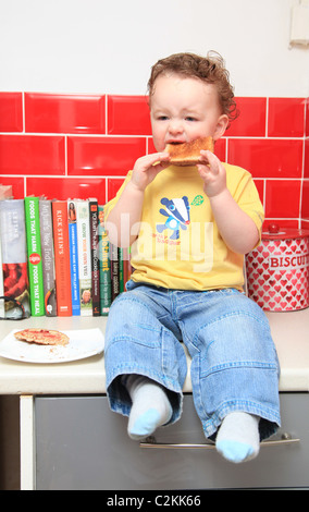 Boy Eating Jam on Toast Stock Photo - Alamy