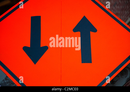 Road sign with two black arrows pointing down and in different Stock ...