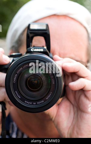 Mature Photographer having fun with his Canon Stock Photo - Alamy