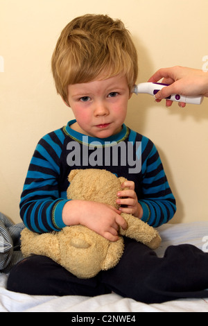 Boy having his temperature taken with a digital thermometer Stock Photo ...