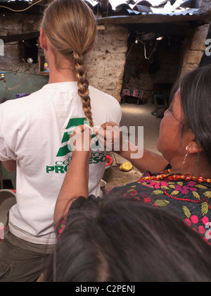 Guatemalan woman in traditional dress, walking towards chicken buses ...