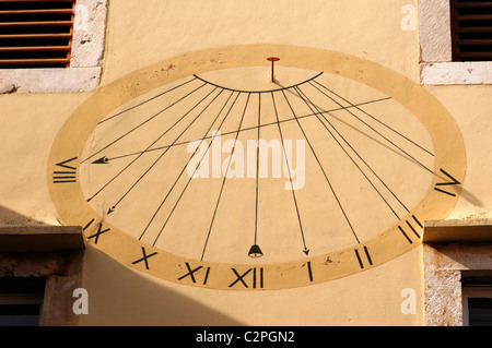 A detail of the old sundial painted on the external wall of the little ...